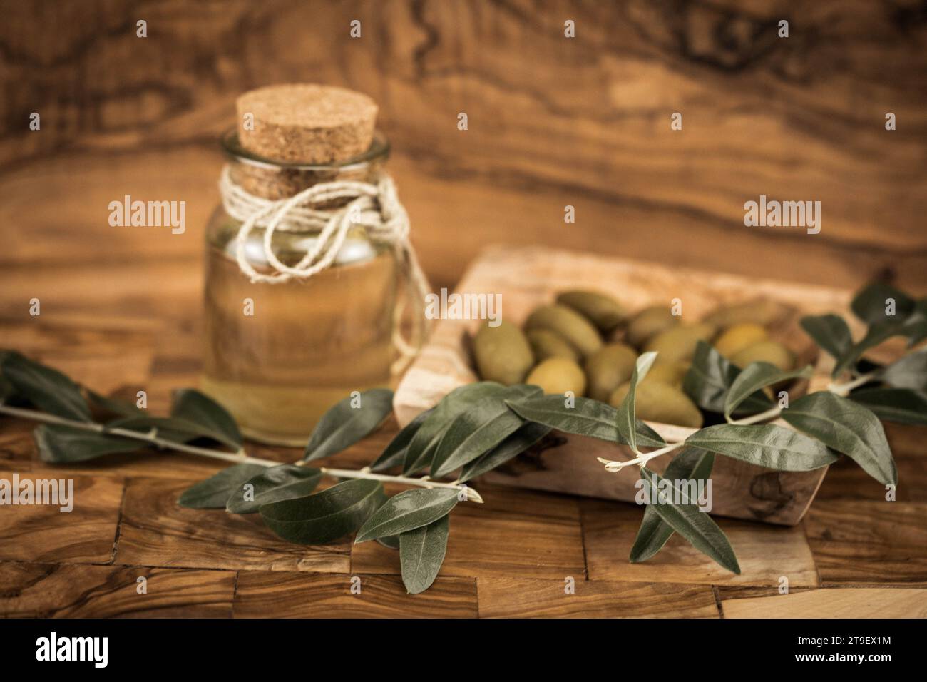 cold pressed extra virgin olive oil on olive wood Stock Photo - Alamy