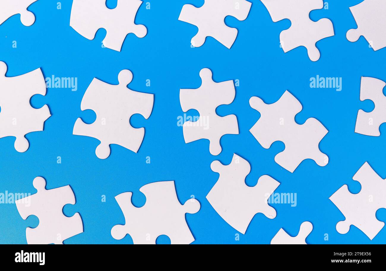 Scattered puzzle pieces in chaos, mess Stock Photo - Alamy