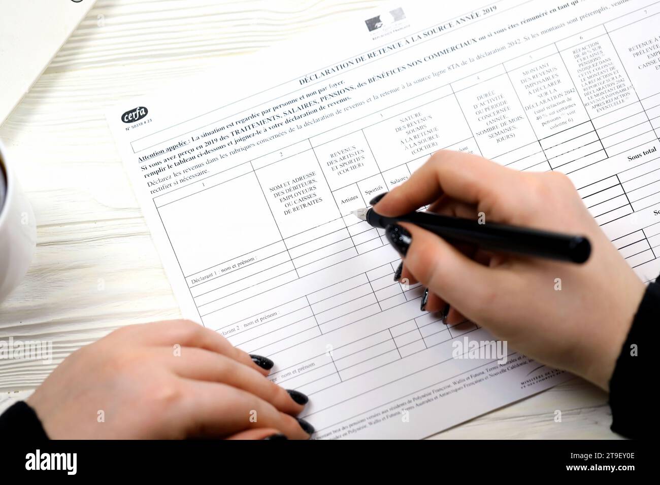 KYIV, UKRAINE - OCTOBER 31, 2023 Accountant fill french tax form 2041E ...