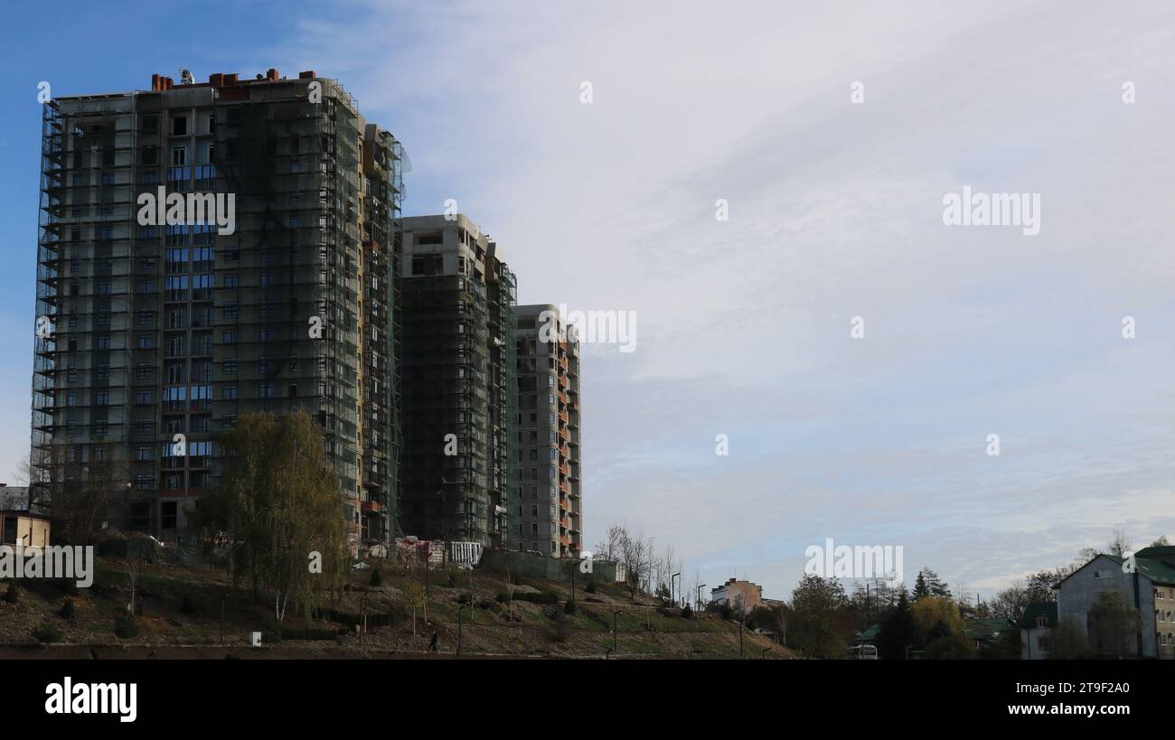 three high-rise buildings on a hill in the process of finishing ...