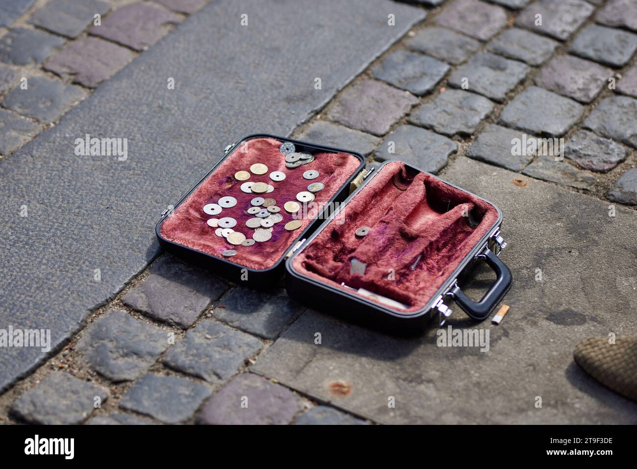 Street musician's instrument case with coins from passers-by Stock ...