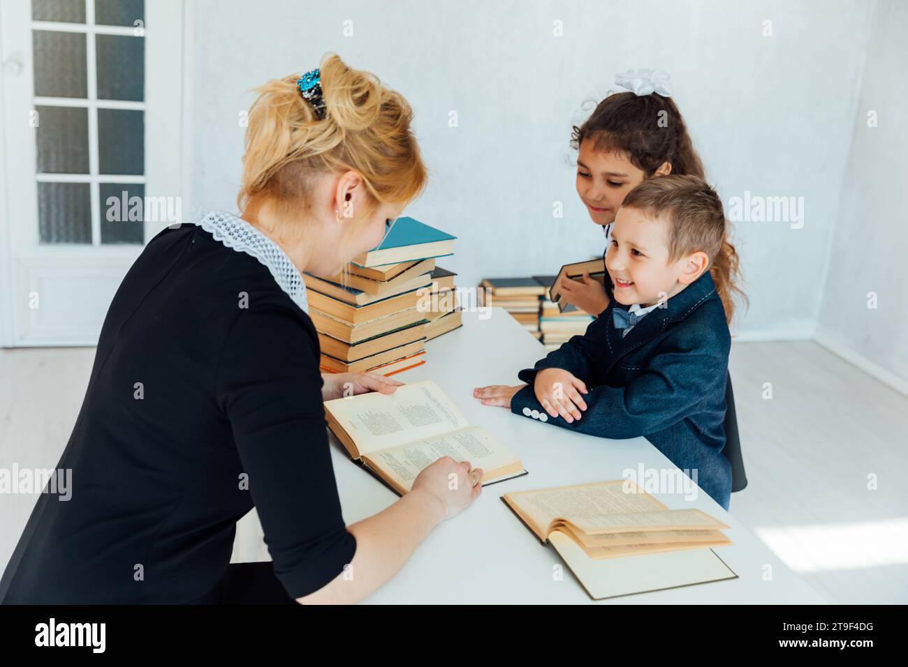 Female teacher teaching children in school classroom Stock Photo - Alamy