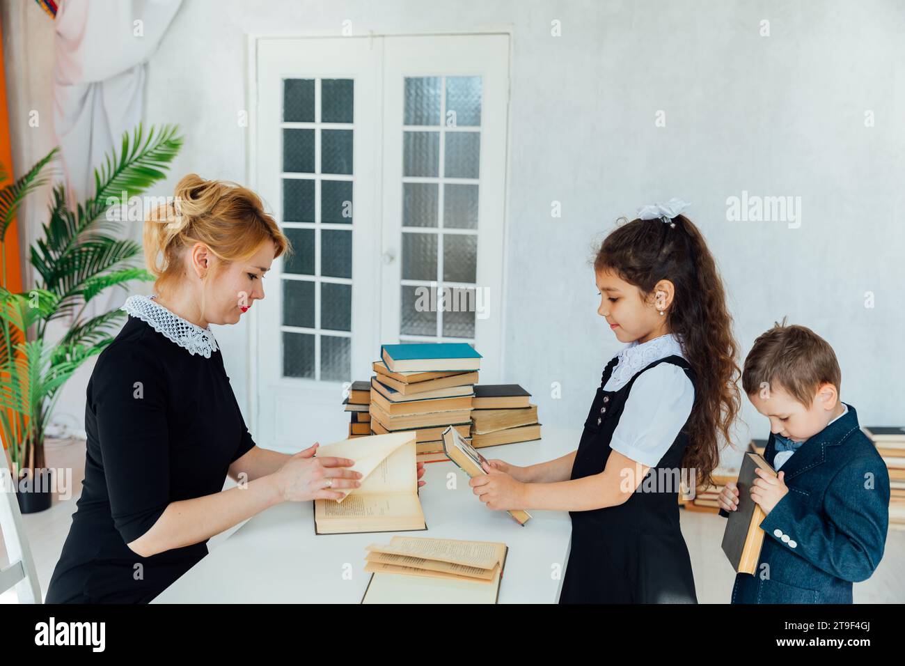 Female teacher teaching children in school classroom Stock Photo - Alamy