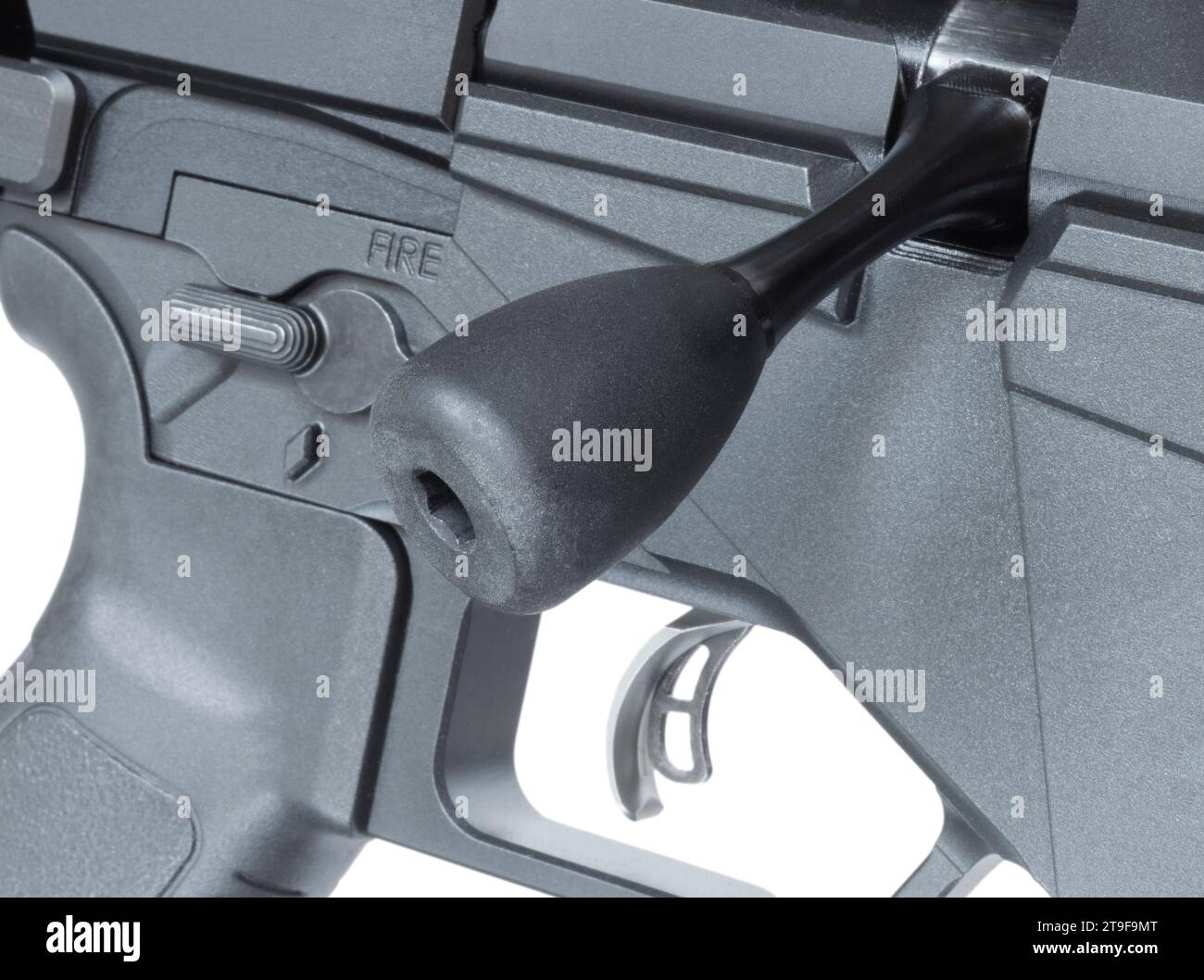 Bolt handle on a modern rifle with trigger and safety visible behind ...