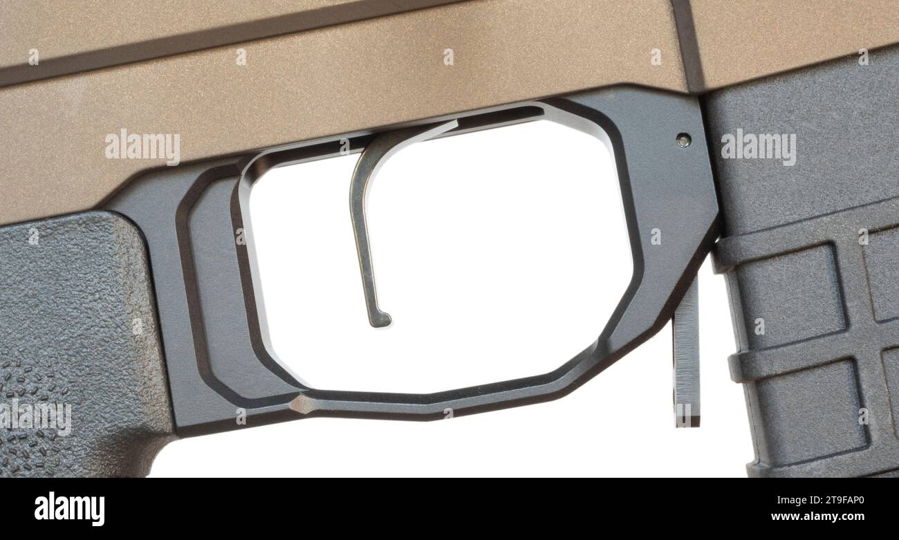 Trigger on a bronze colored high power rifle seen from the side with a ...