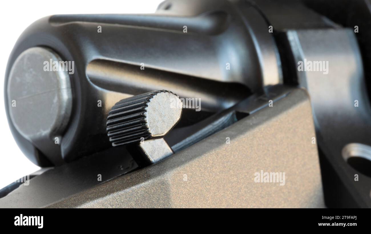 Safety engaged on a metallic copper finished bolt action rifle in the ...