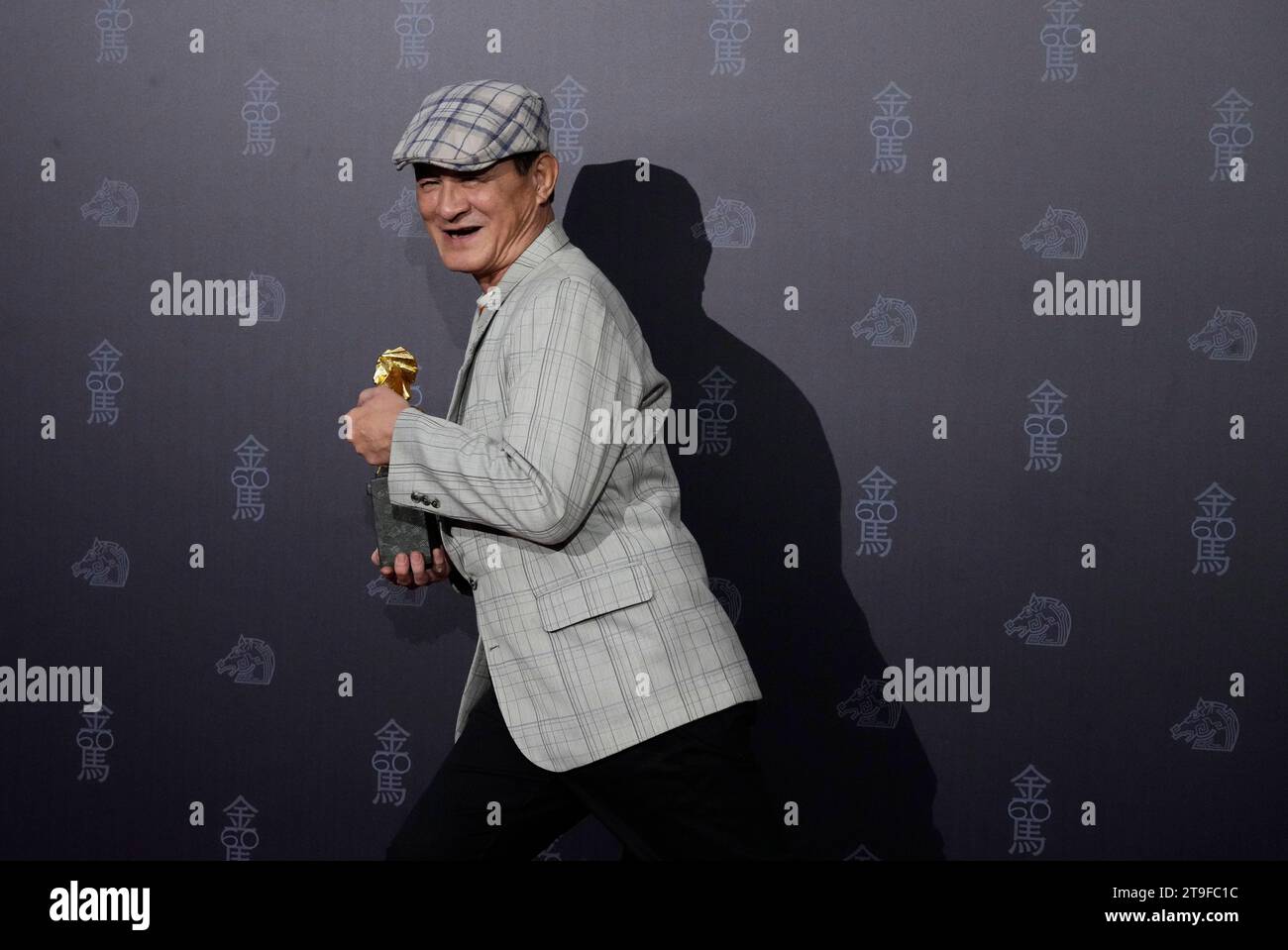 Taiwanese actor Akio Chen holds his award for Best Supporting Actor at ...
