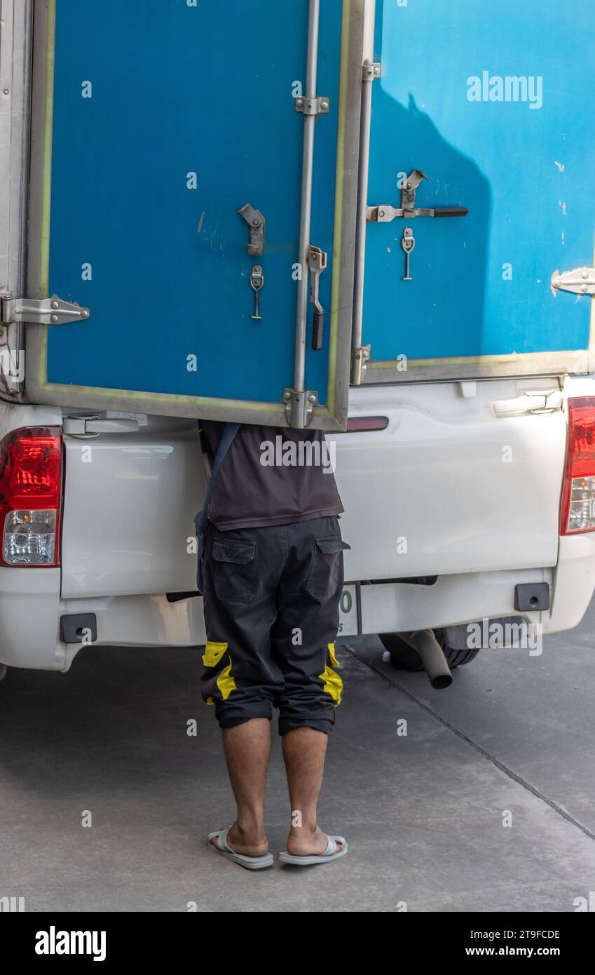 The courier of the delivery service checks the parcels in the car Stock ...