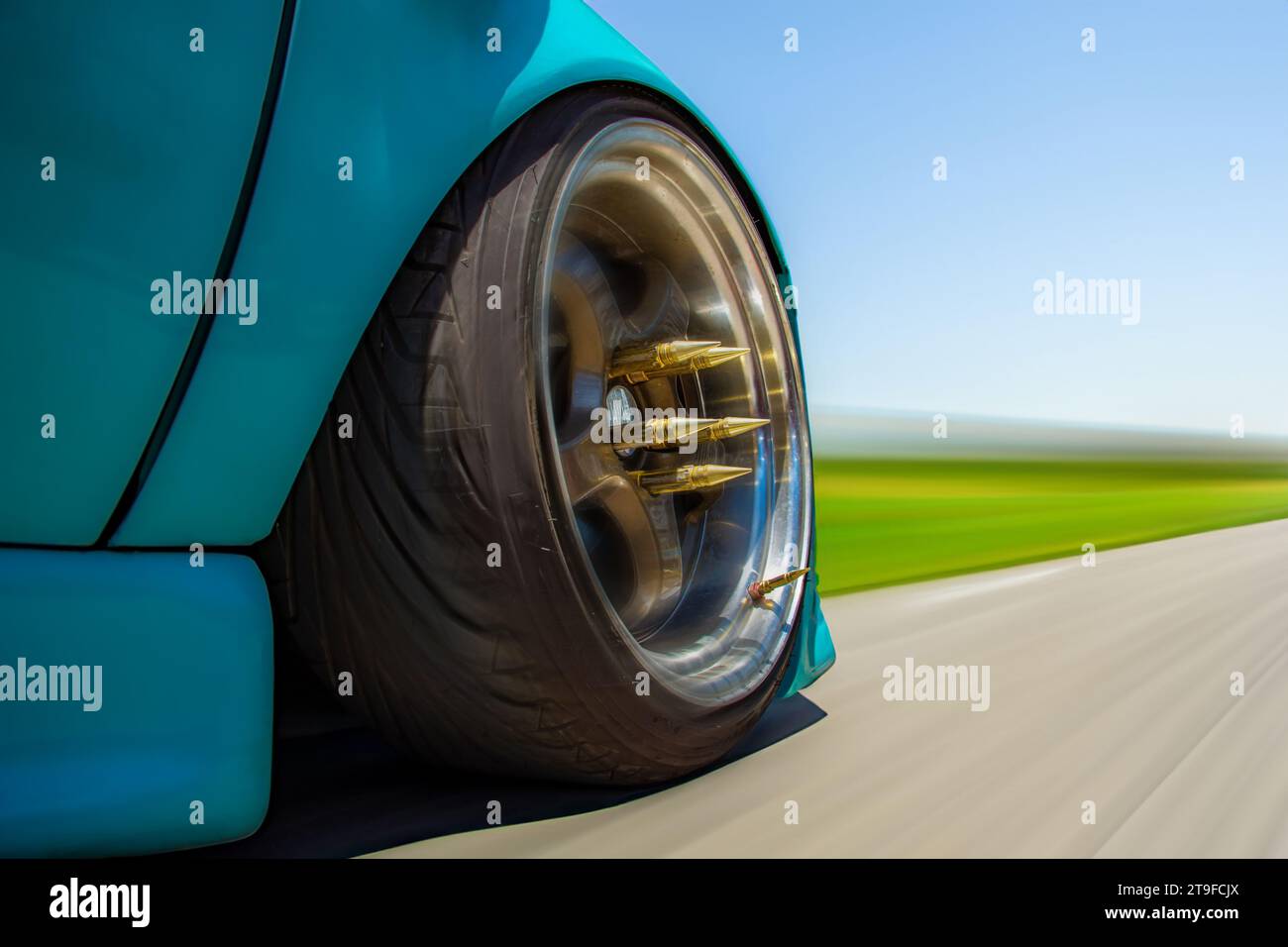 The front wheel of a tuning car driving fast on the road Stock Photo ...