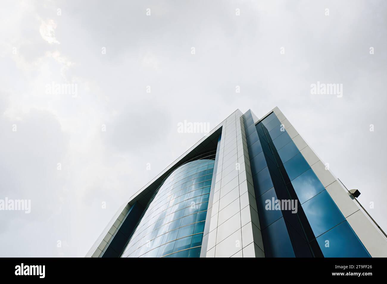 Huge corporate office building exterior against the cloudy weather ...