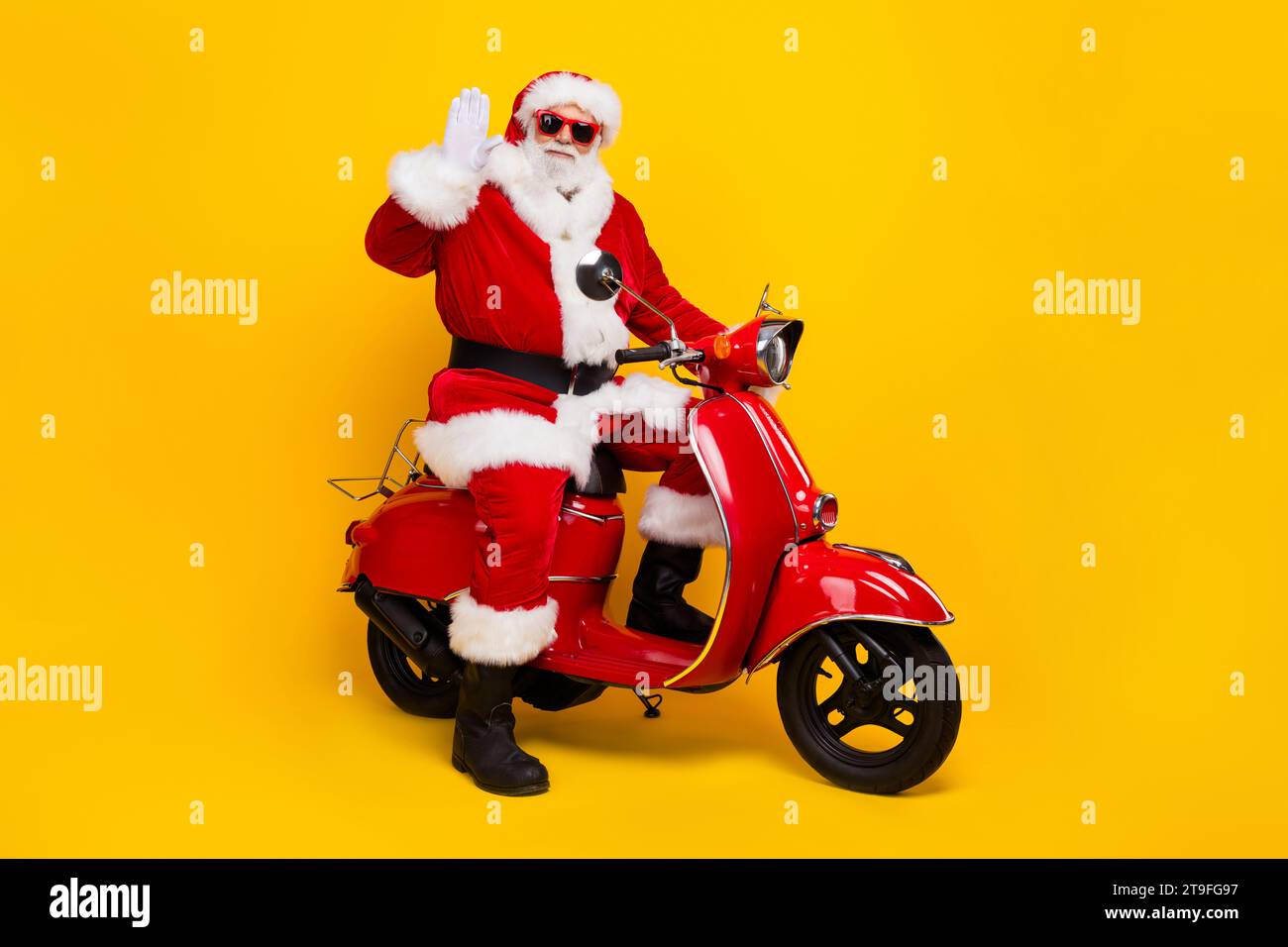 Full body profile photo of charismatic aged santa drive bike arm palm ...