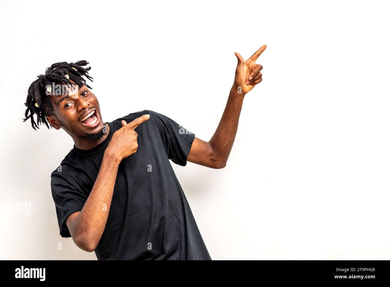 Surprised young man pointing hi-res stock photography and images - Alamy