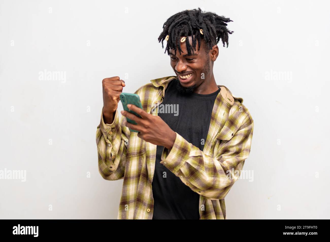 excited young african boy on dreadlocks using smartphone Stock Photo ...