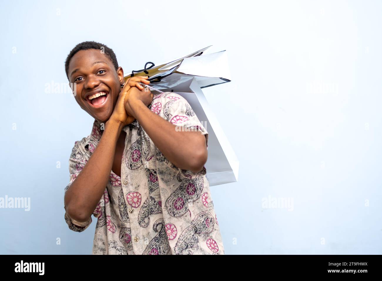 Black Friday, happy young guy carrying shopping bag. Big sales Stock ...