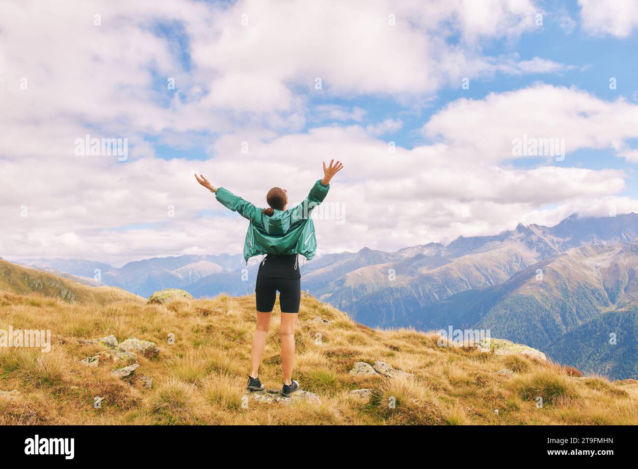 Outdoor portrait of happy young woman hiking in autumn mountains, back ...