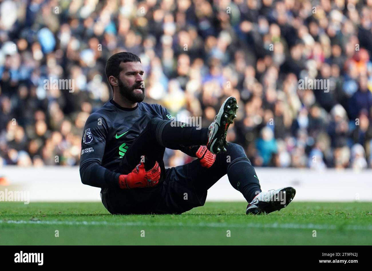 Liverpool goalkeeper Alisson Becker sits injured during the Premier ...