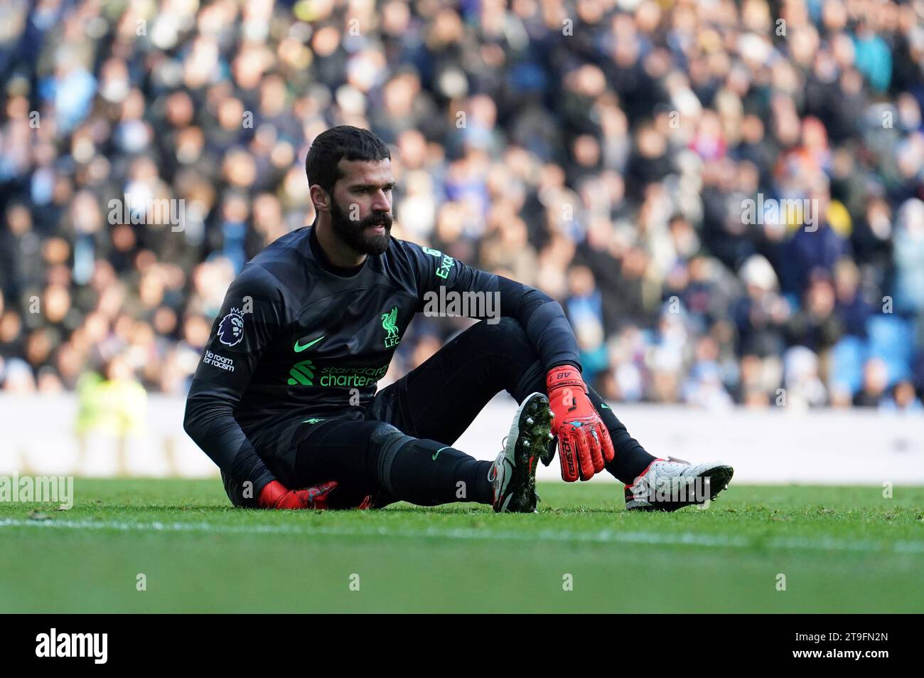 Liverpool goalkeeper Alisson Becker sits injured during the Premier ...