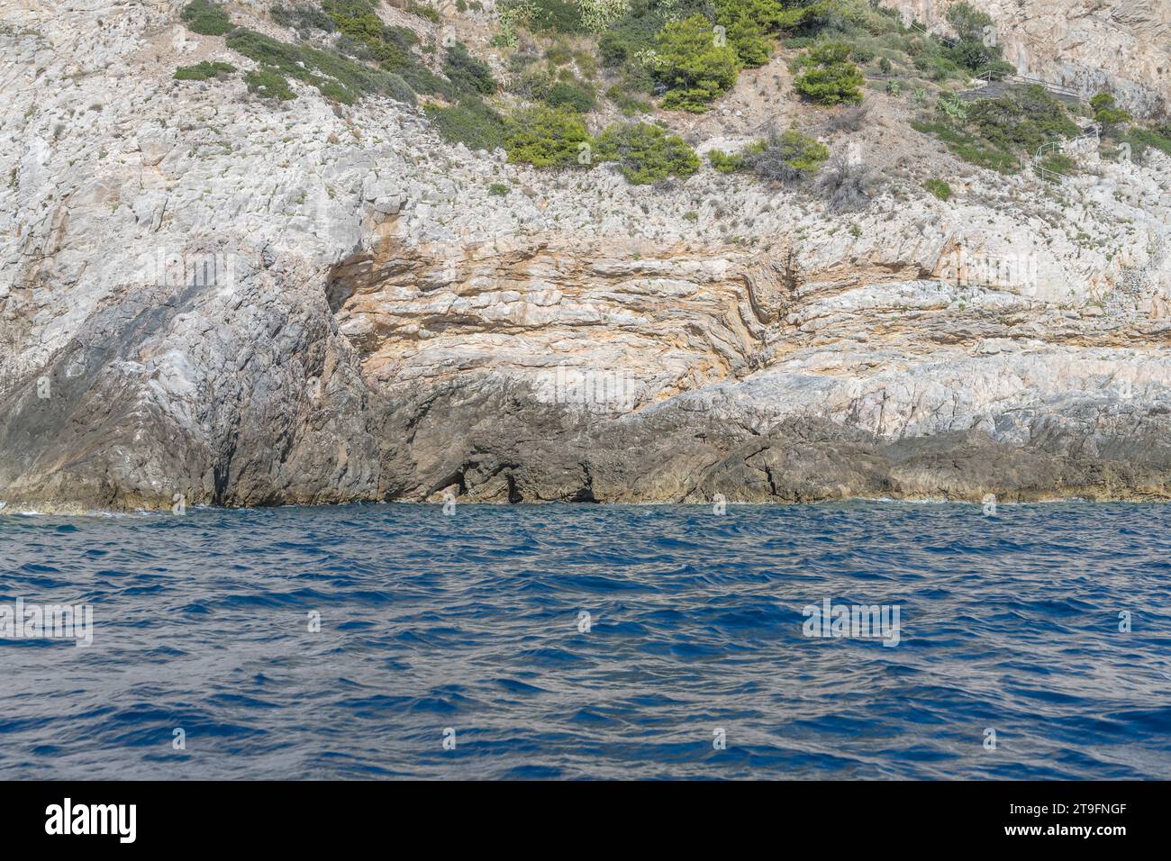 detail of layered igneous rocks in steep layered cliffs of Piatti cape ...