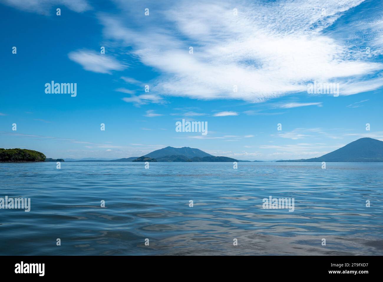 Tiny Islands Seen From Afar with Volcanic Mountains, Lush Vegetation ...