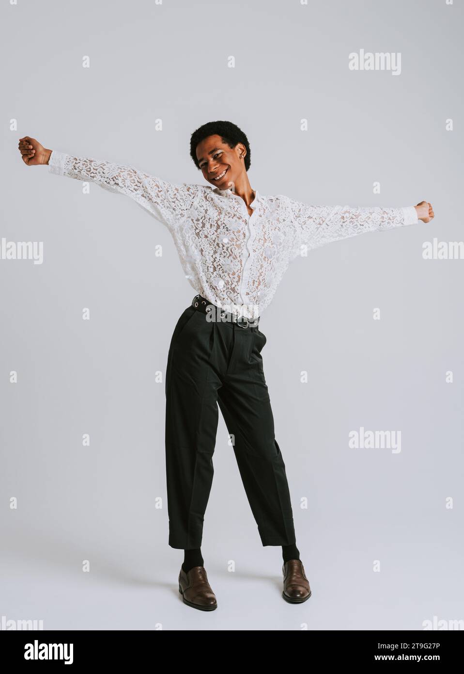 Fluid gender hispanic latin black man posing in studio with fashionable ...