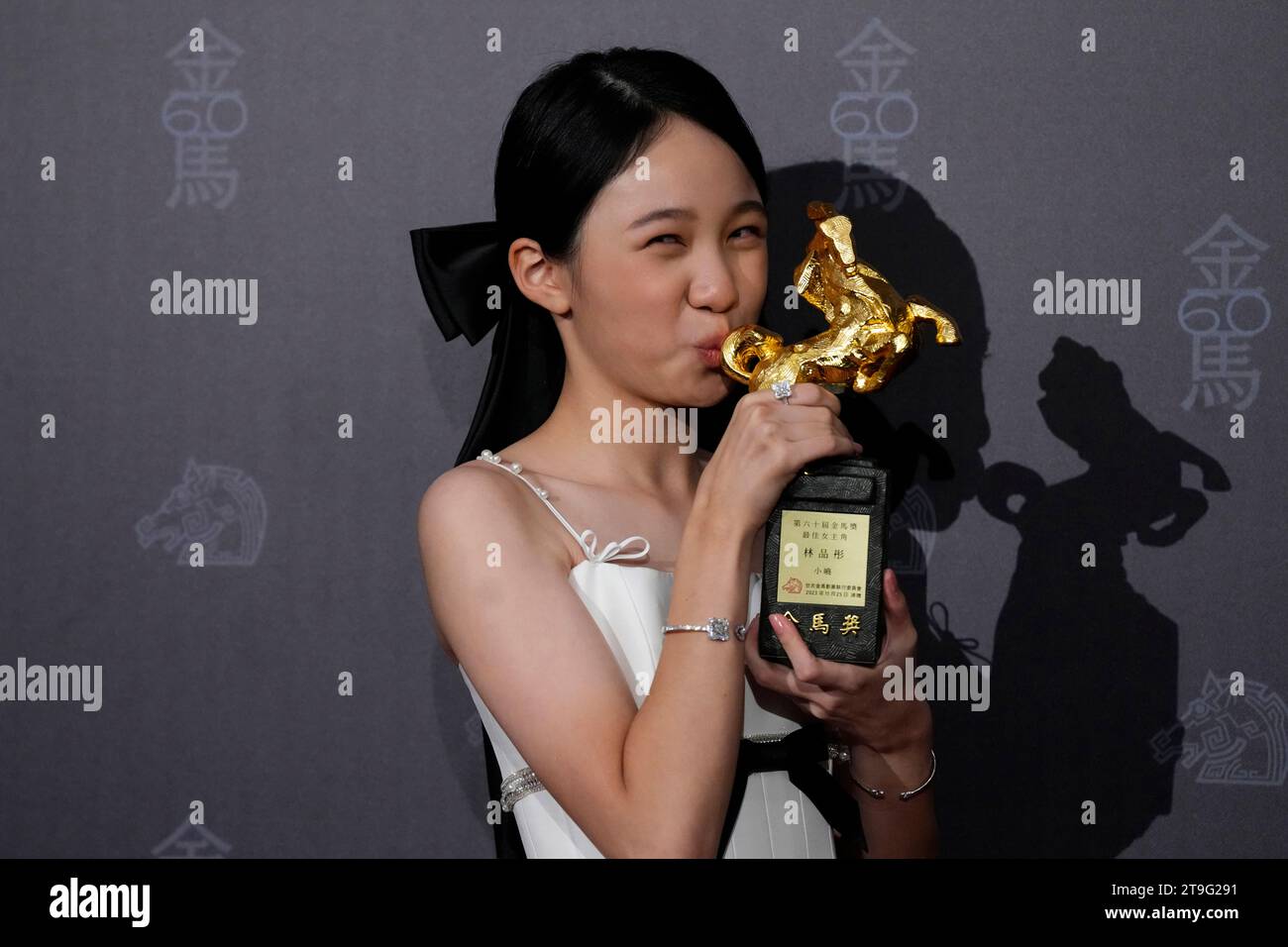 Taiwanese actress Audrey Lin kisses her award for Best Leading Actress ...