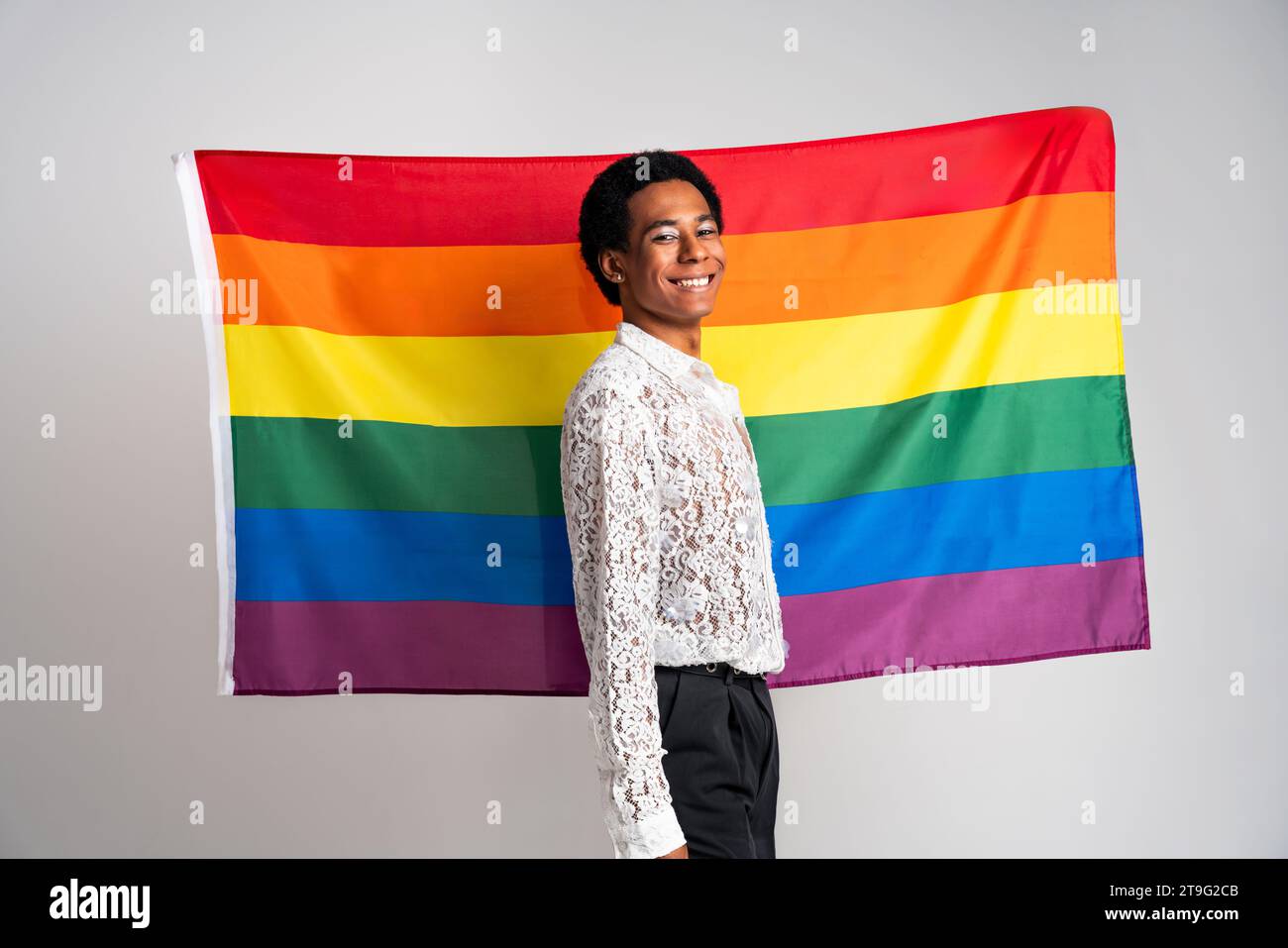 Fluid gender hispanic latin black man posing in studio with fashionable ...