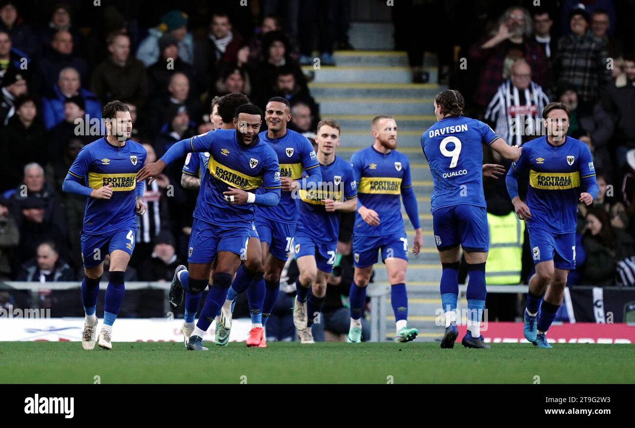 AFC Wimbledon's Jake Reeves (left) celebrates scoring the opening goal ...