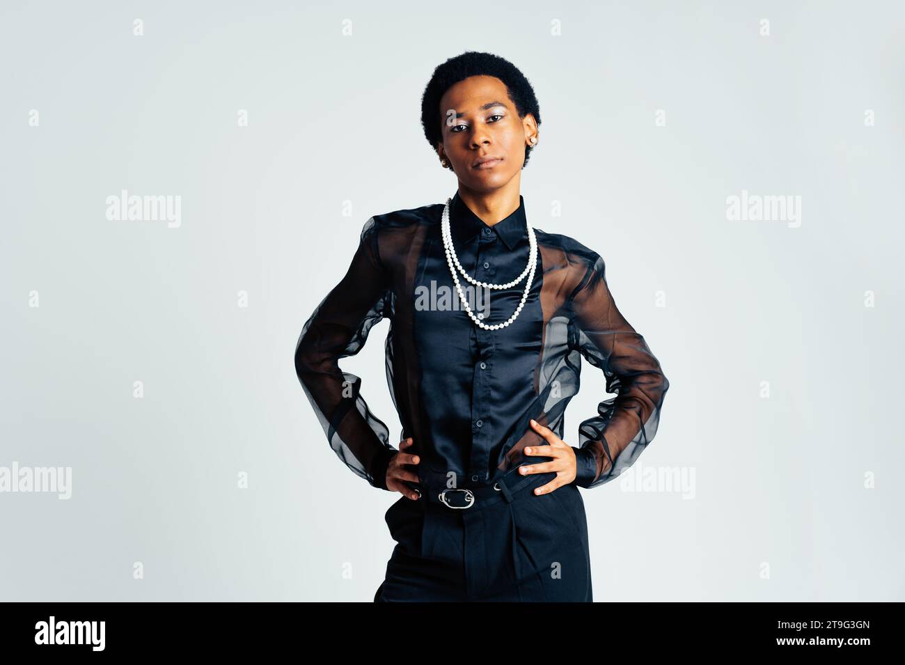 Fluid gender hispanic latin black man posing in studio with fashionable ...