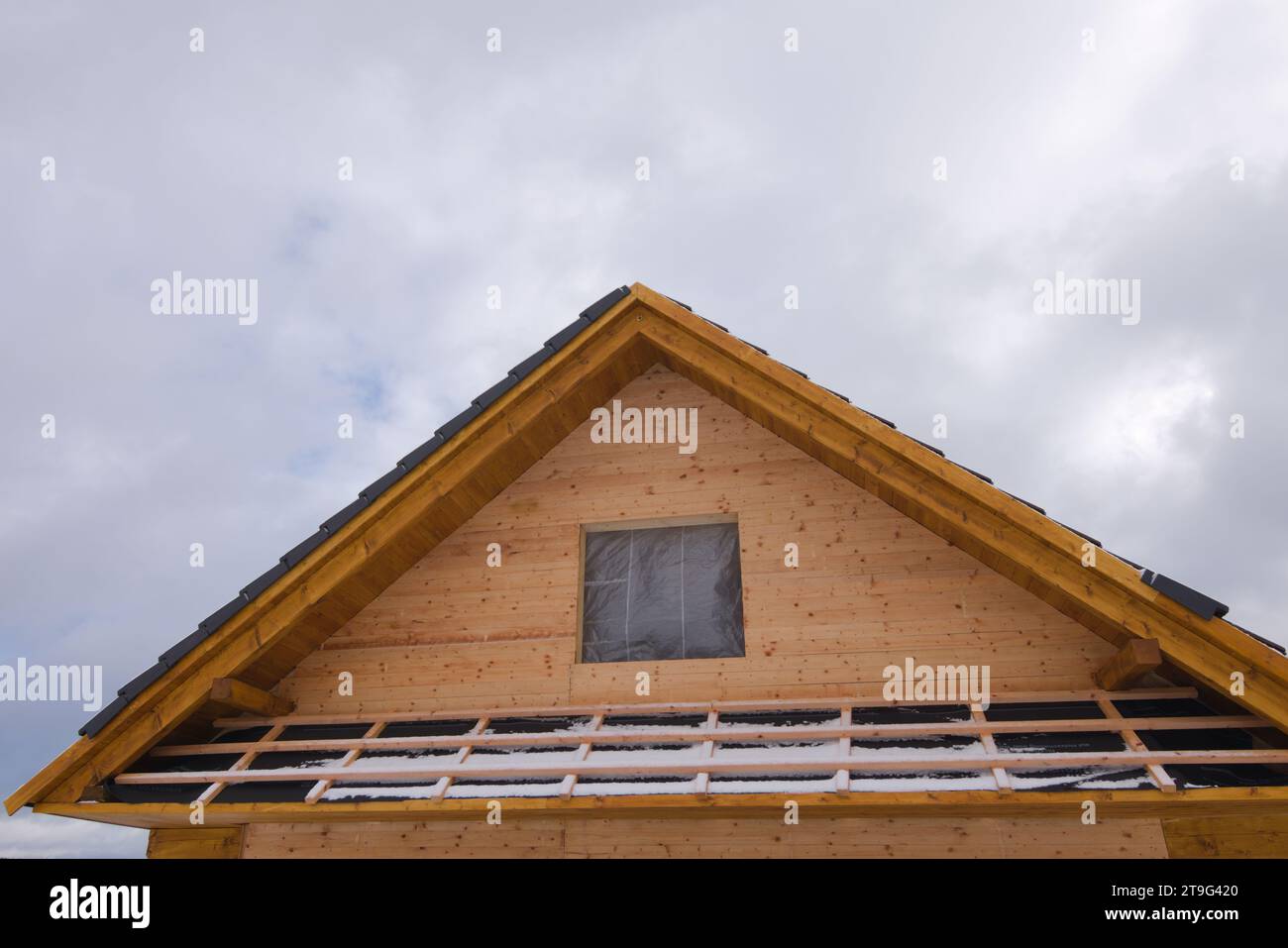 Construction of unfinished house made of bricks, wood and timber ...
