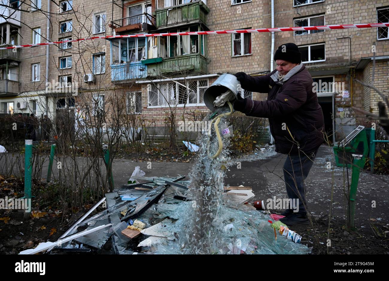 Kyiv, Ukraine. 25th Nov, 2023. A man takes out broken glasses from a ...