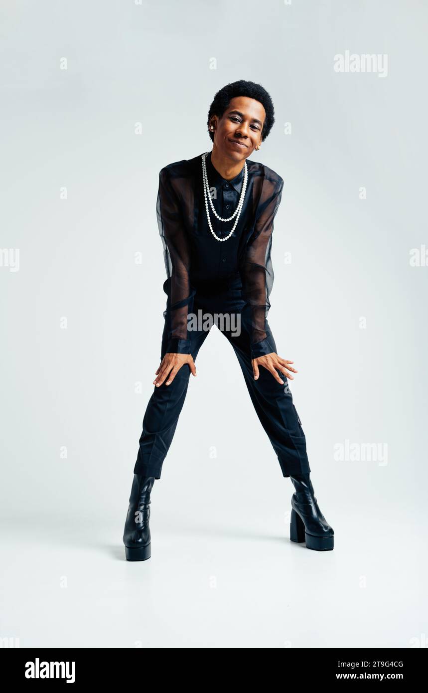Fluid gender hispanic latin black man posing in studio with fashionable ...