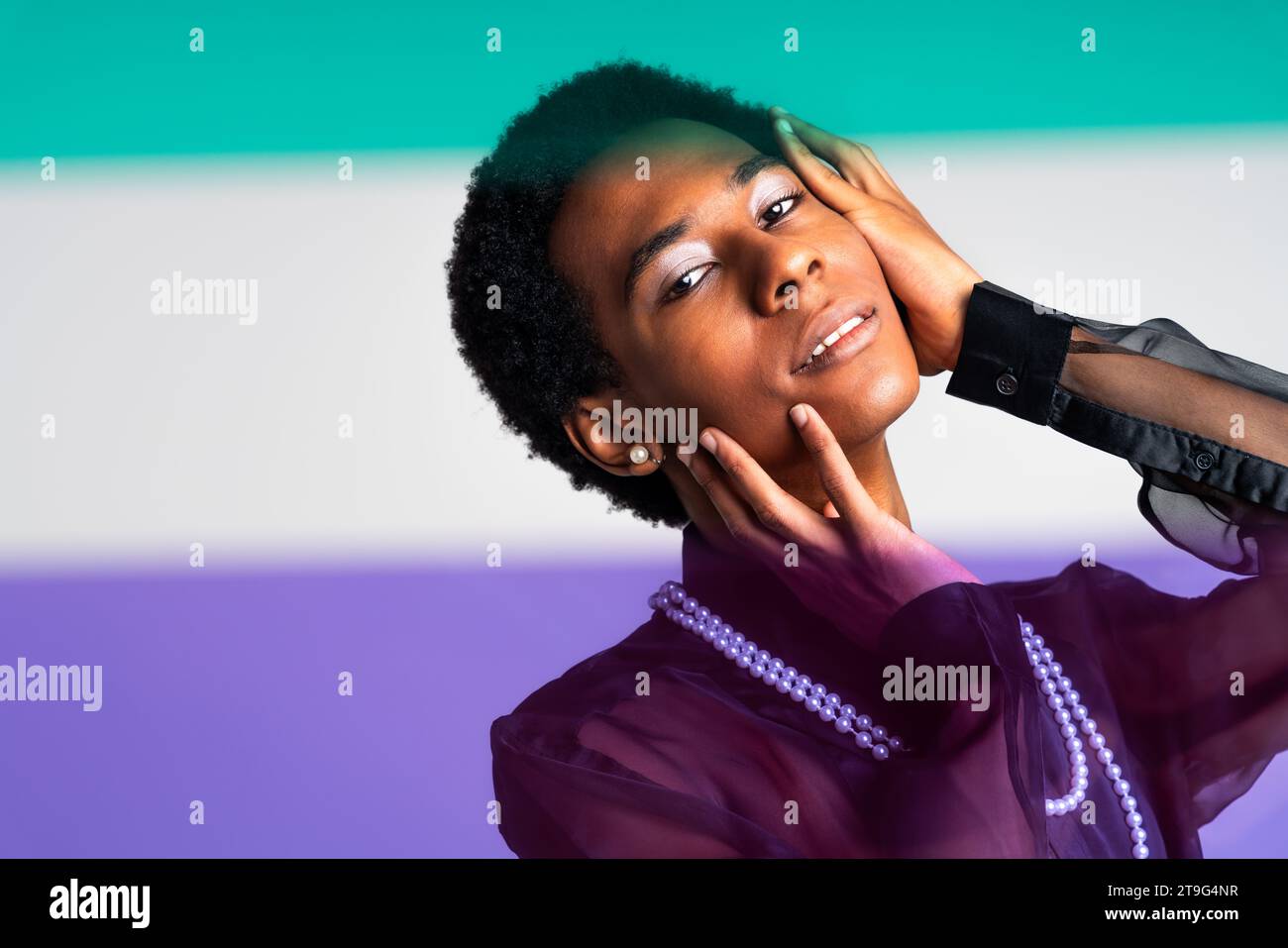 Fluid gender hispanic latin black man posing in studio with fashionable ...