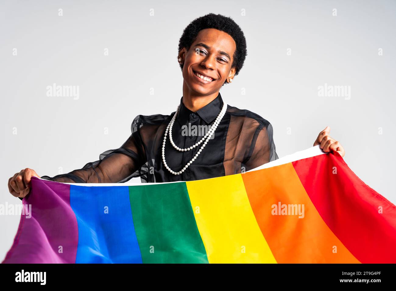 Fluid gender hispanic latin black man posing in studio with fashionable ...