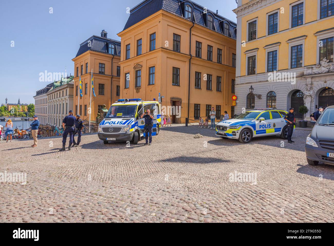 Police officers standing by their patrol cars, ensuring law and order ...