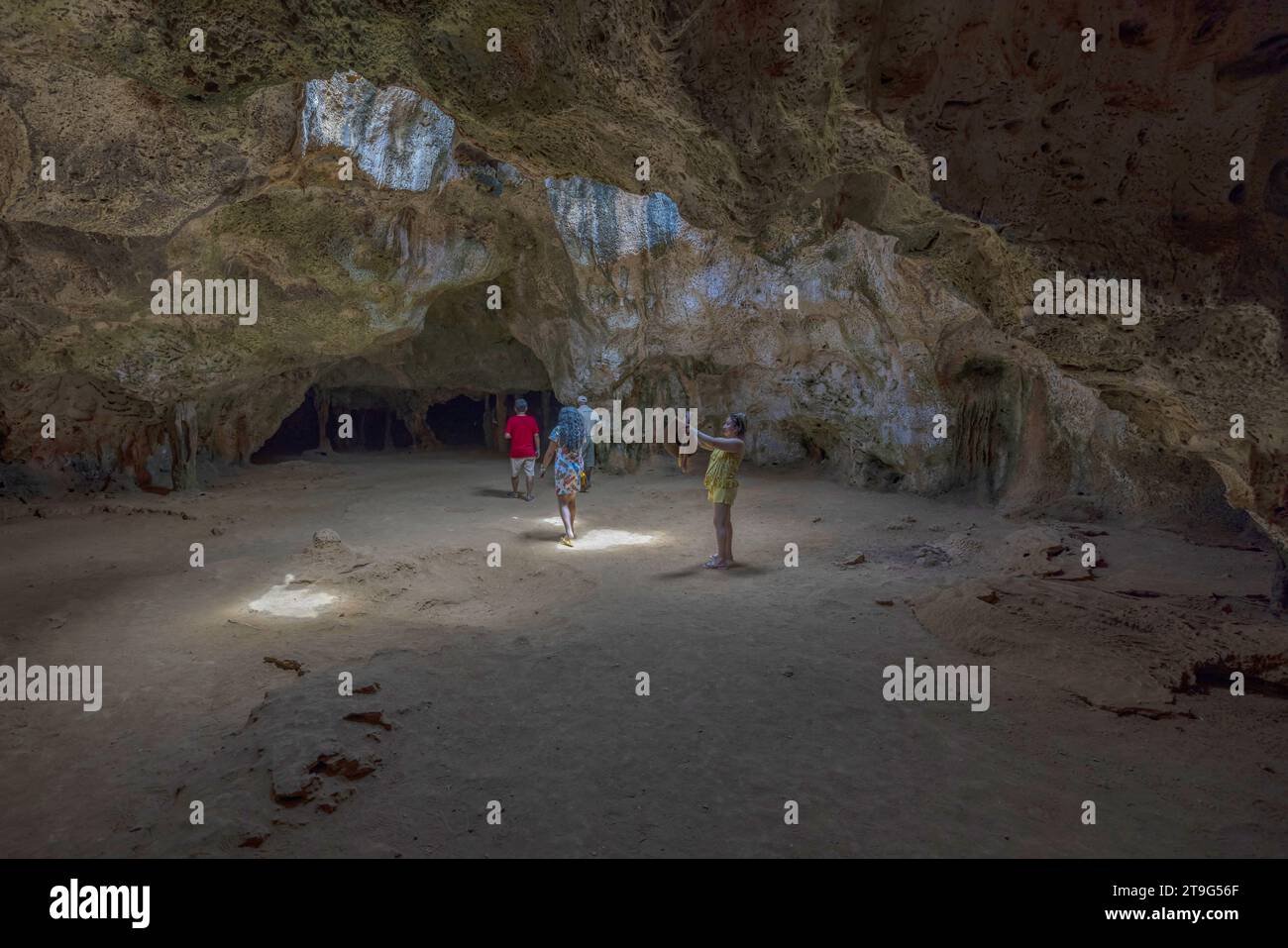 Captivating scene of Quadirikiri Caves in Arikok National Park on island of Aruba, with tourists ...