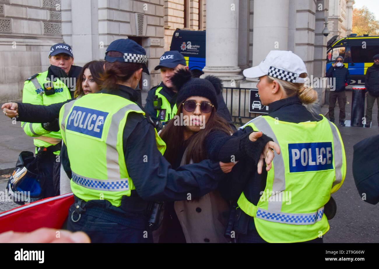 London, England, UK. 25th Nov, 2023. Police officers detain a woman for ...