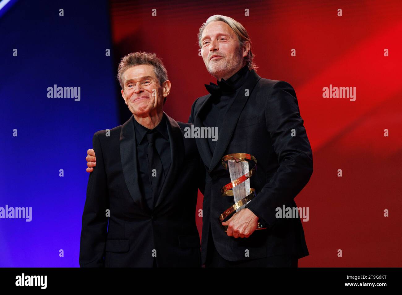 Mads Mikkelsen receives the tribute award from Willem Dafoe during the ...