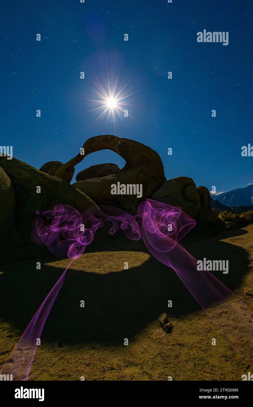 Mobius Arch lit by full moon on clear night, Alabama Hills, California ...