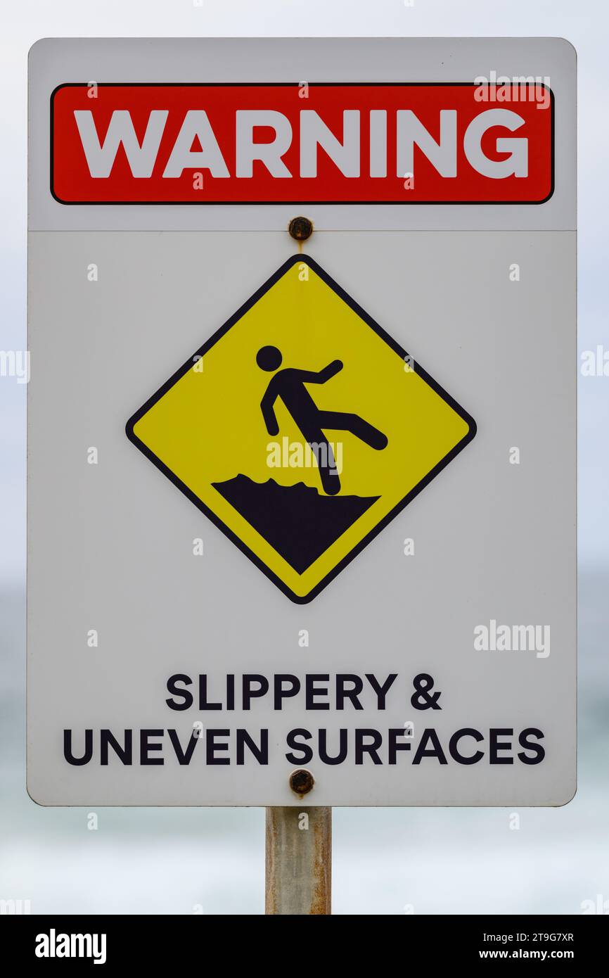 Warning sign of slipping or uneen surfaces Stock Photo - Alamy