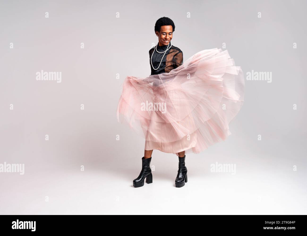 Fluid gender hispanic latin black man posing in studio with fashionable ...