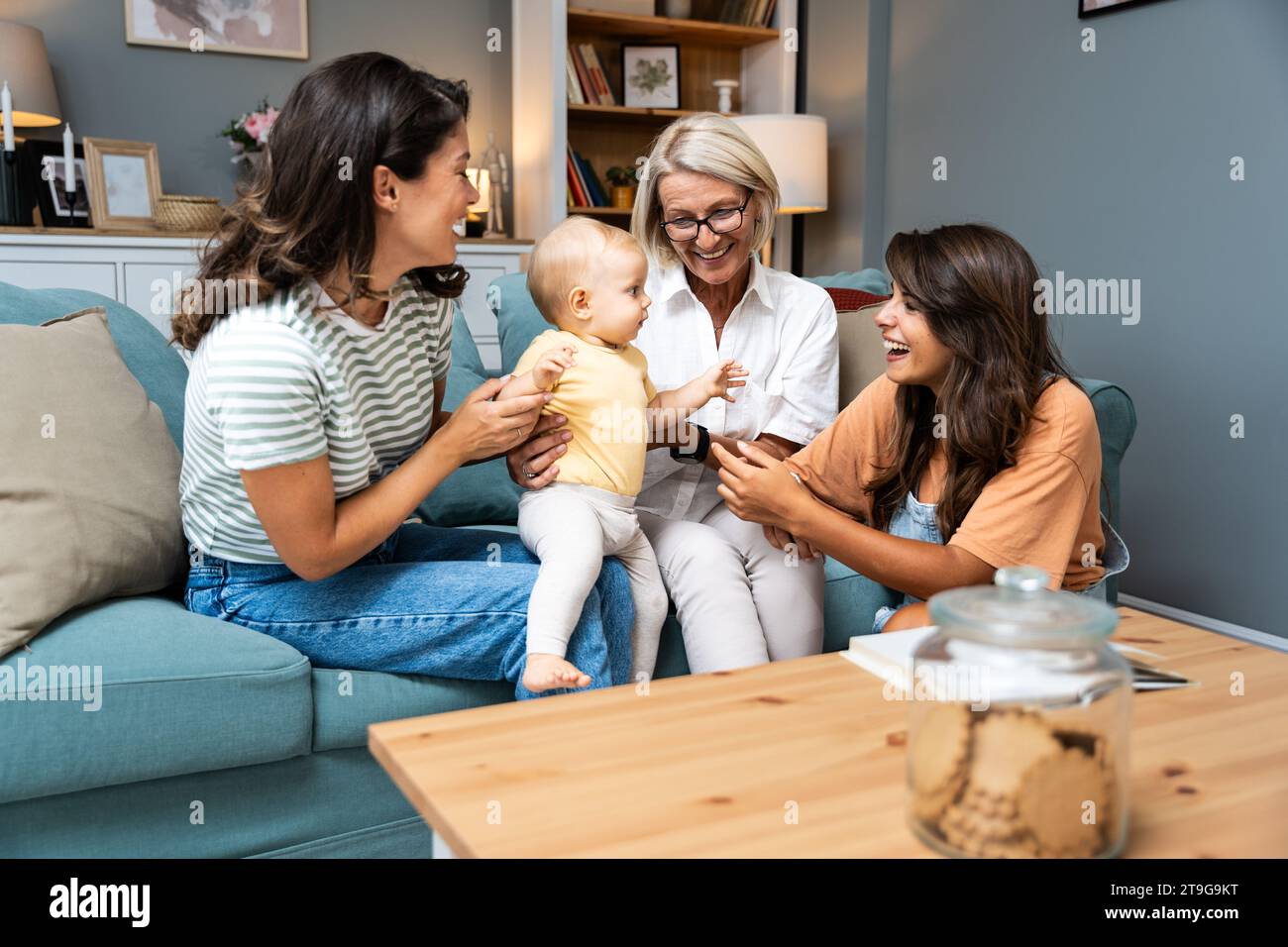 Happy family. Grandmother, mother, aunt and little baby having fun at ...