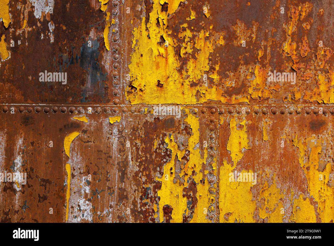 beautifully rusted rivetted sheet metal with leftovers of yellow paint ...