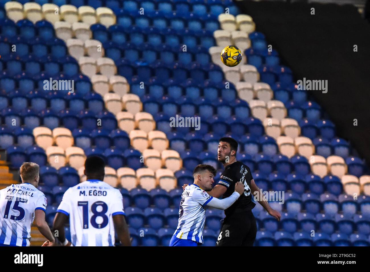 Niall Canavan (6 Barrow) heads the ball challenged by Cameron McGeehan ...