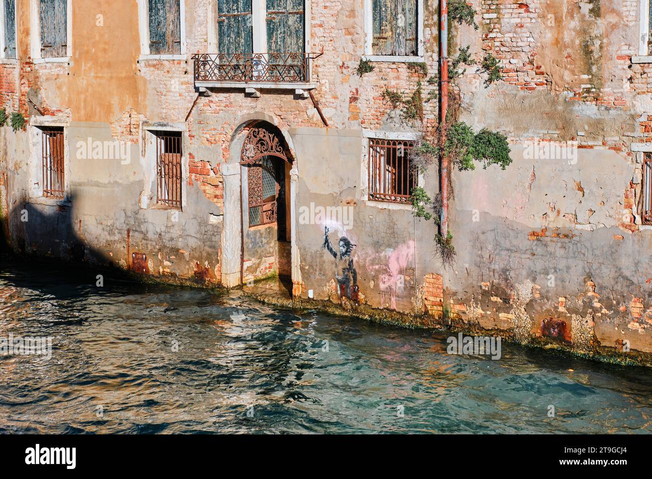 Venice, Italy - November 9 2023: Venice canal waters, gate and graffiti ...