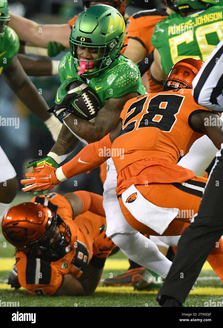 Oregon State defensive back Kitan Oladapo (28) tackles Oregon running ...
