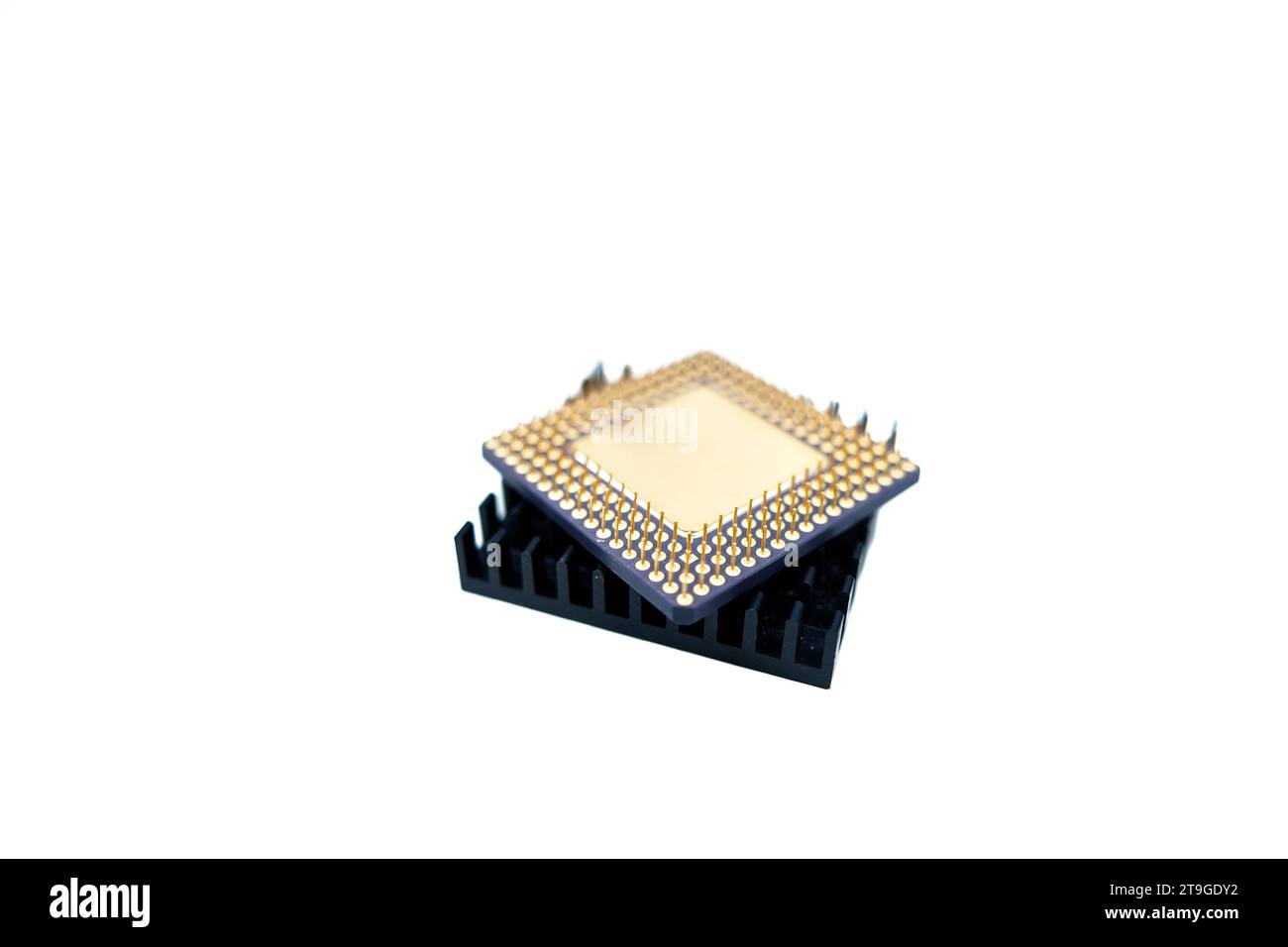 Microprocessor with a heat sink lying on a white surface, isolated on ...