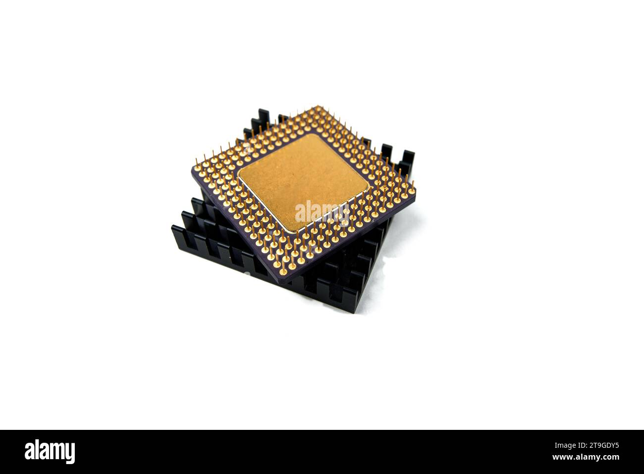 Microprocessor with a heat sink lying on a white surface, isolated on ...