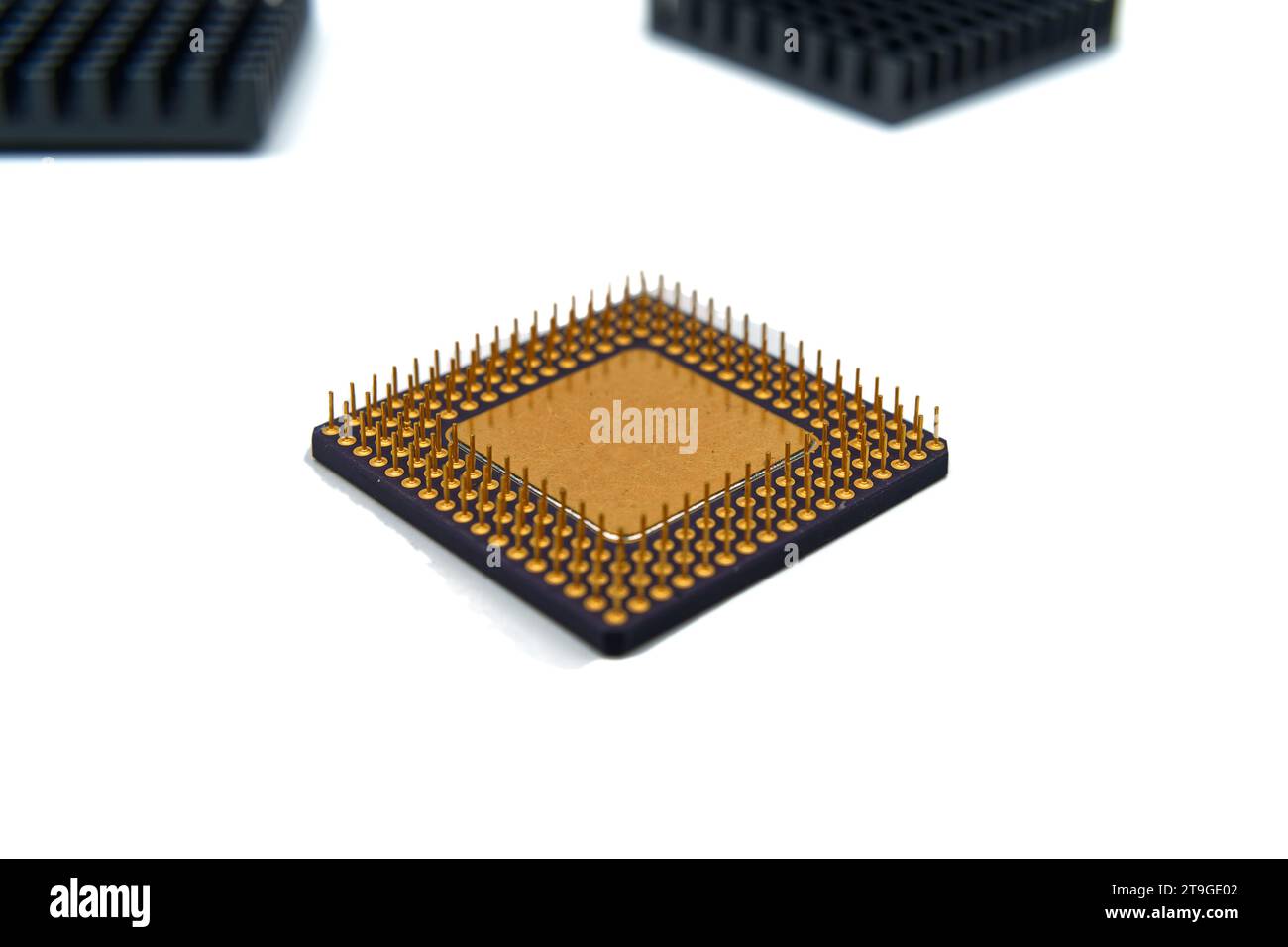 Microprocessor with a heat sink lying on a white surface, isolated on ...