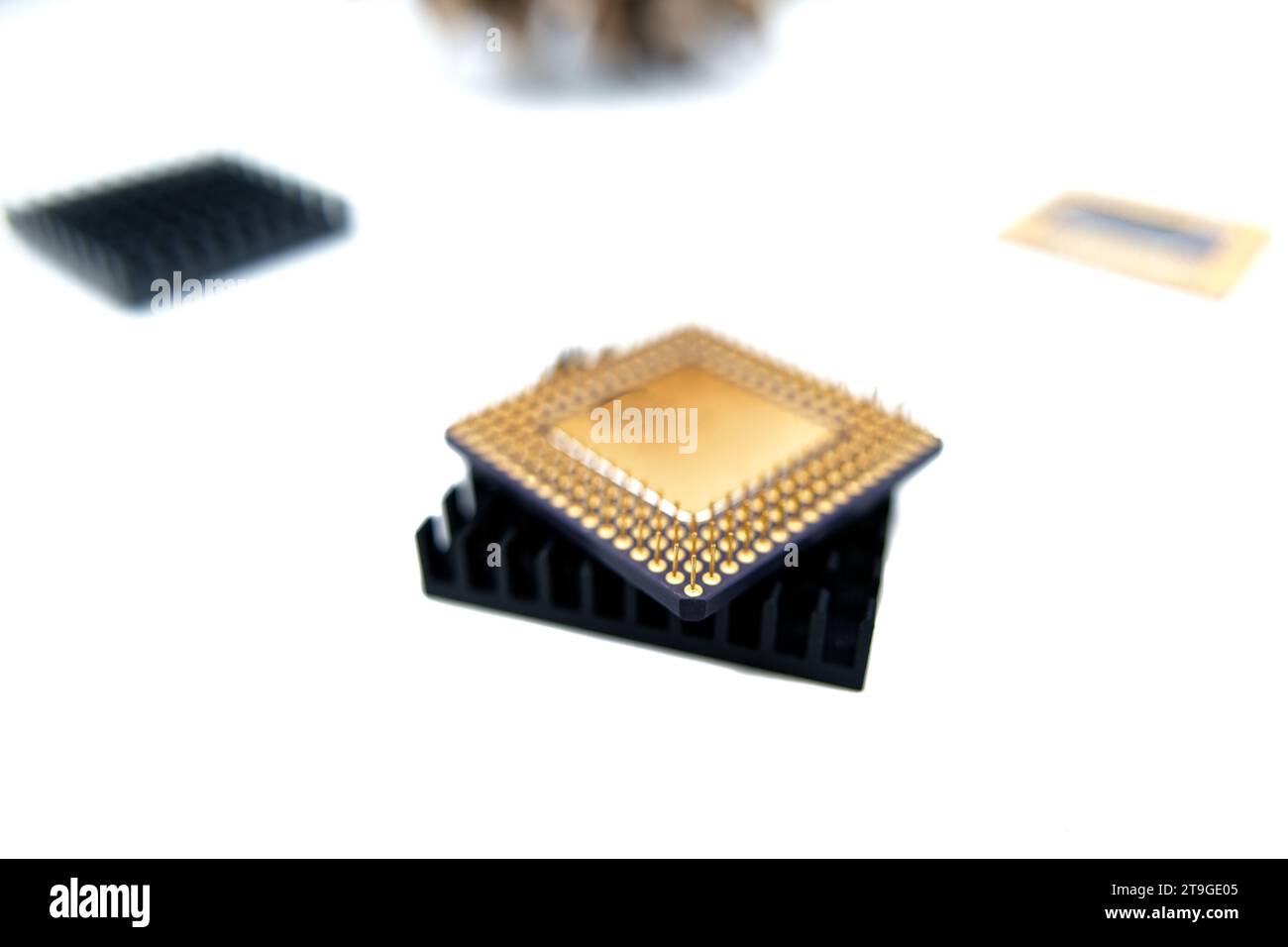Microprocessor with a heat sink lying on a white surface, isolated on ...