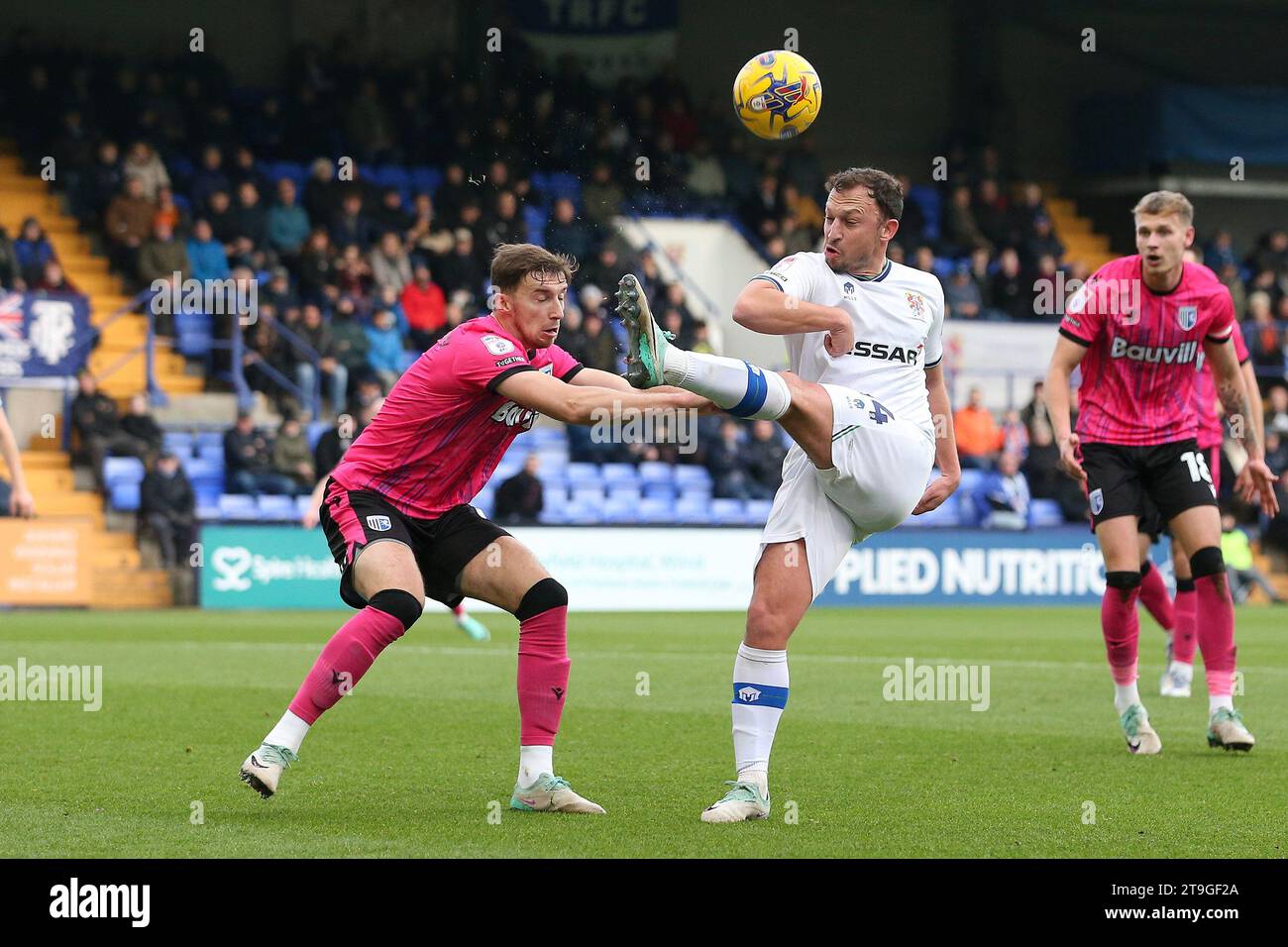 Birkenhead, UK. 25th Nov, 2023. Ethan Coleman of Gillingham (l) and ...
